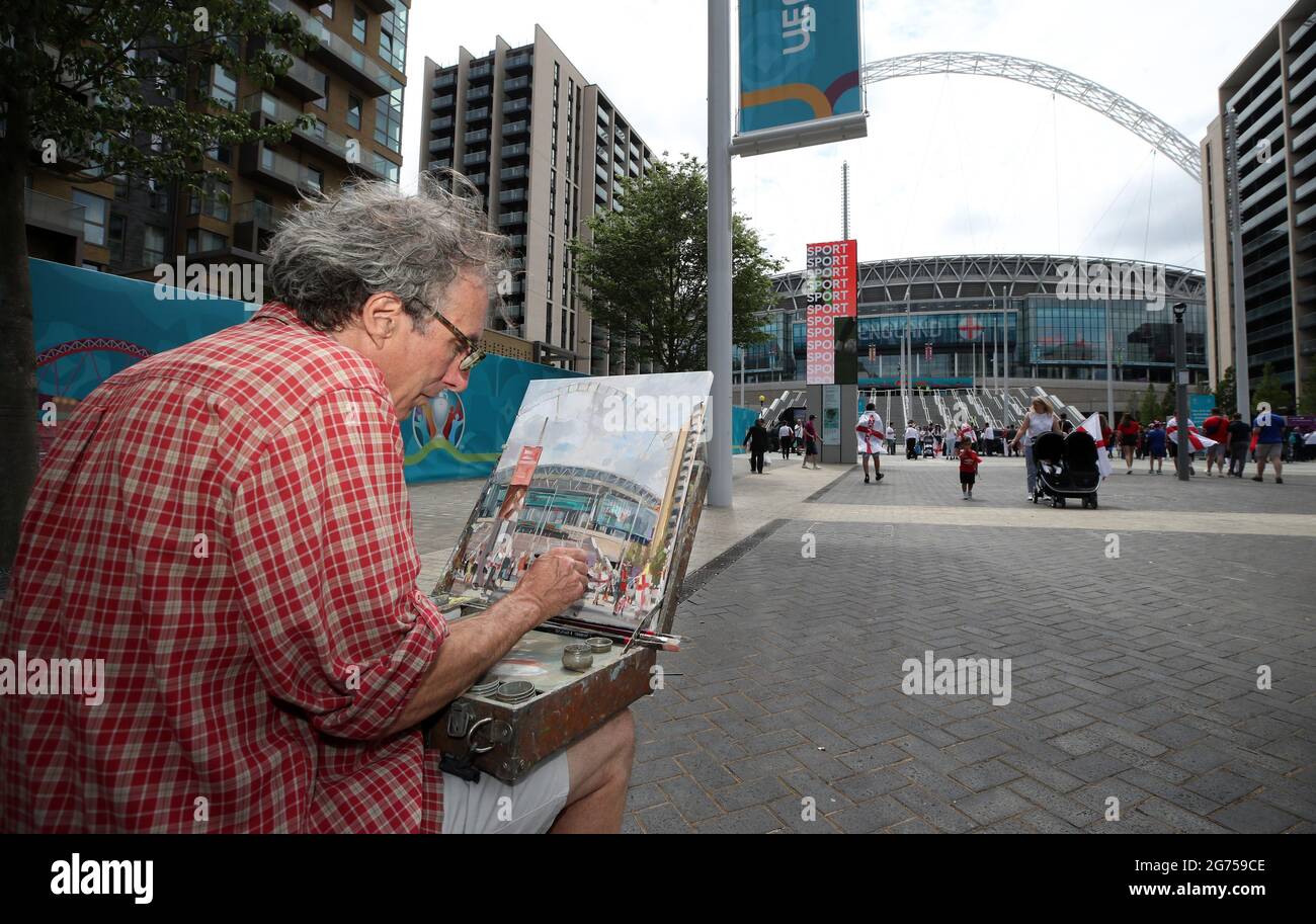 Artist Nick Botting paints an image of the stadium on Wembley Way ...