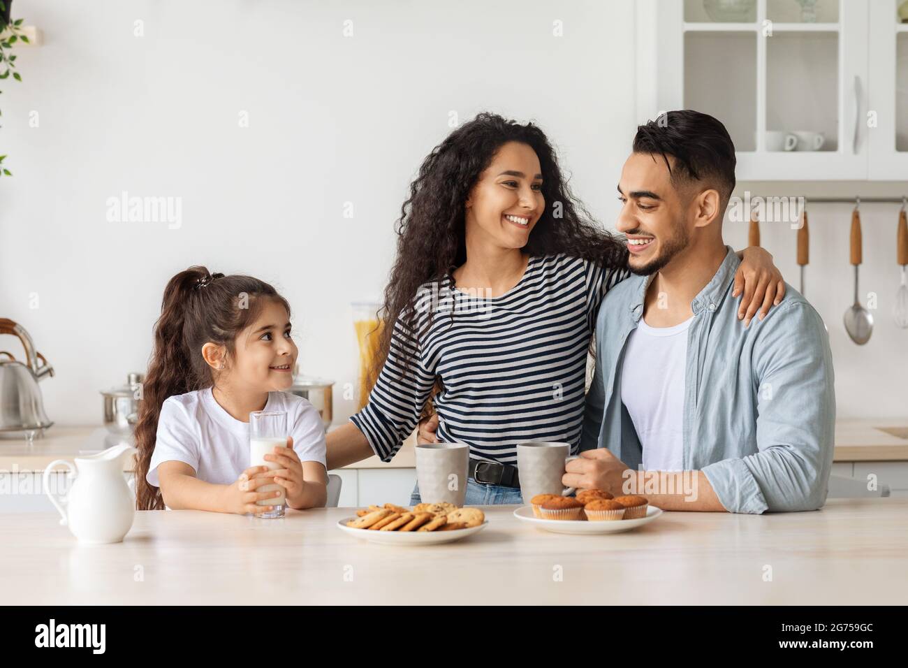 Cute happy family having snack while spending weekend at home Stock ...