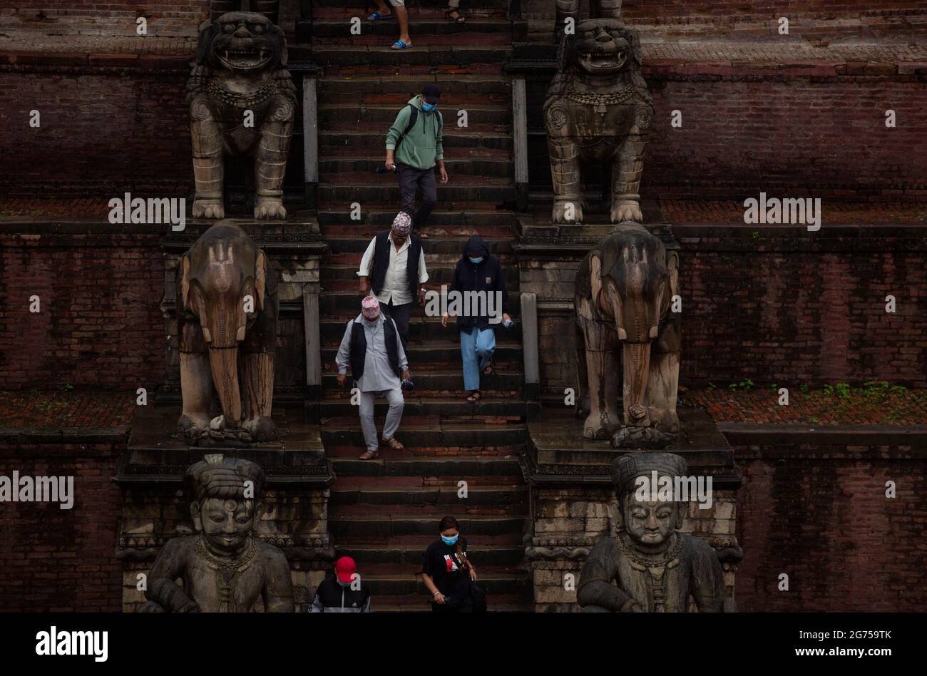 Kathmandu, Nepal. 11th July, 2021. People walk downstairs at the ...