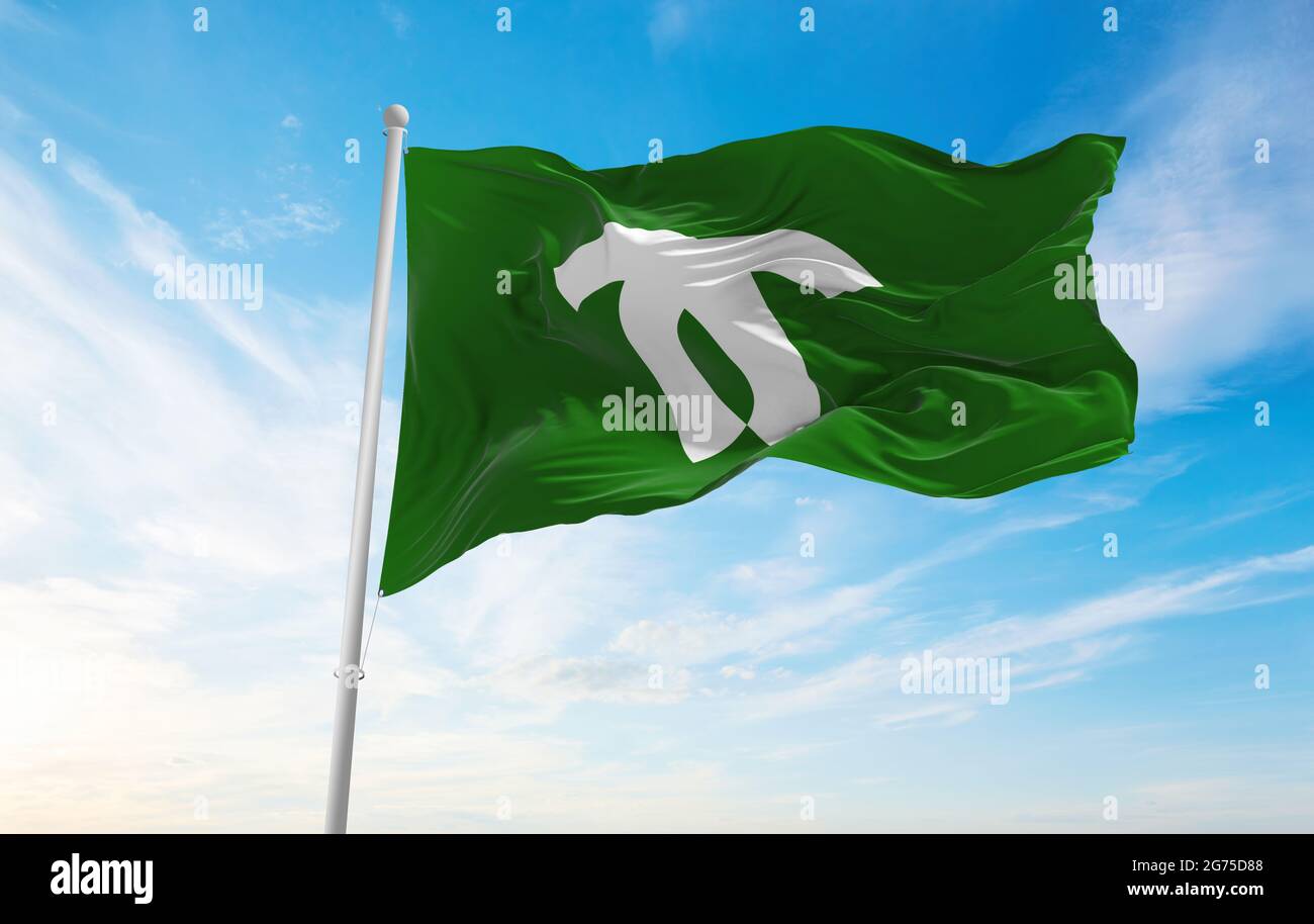 official city flag of Kobe, Hyogo waving in the wind on flagpoles ...