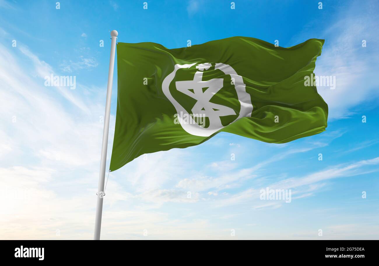 official city flag of Niigata, Niigata waving in the wind on flagpoles ...
