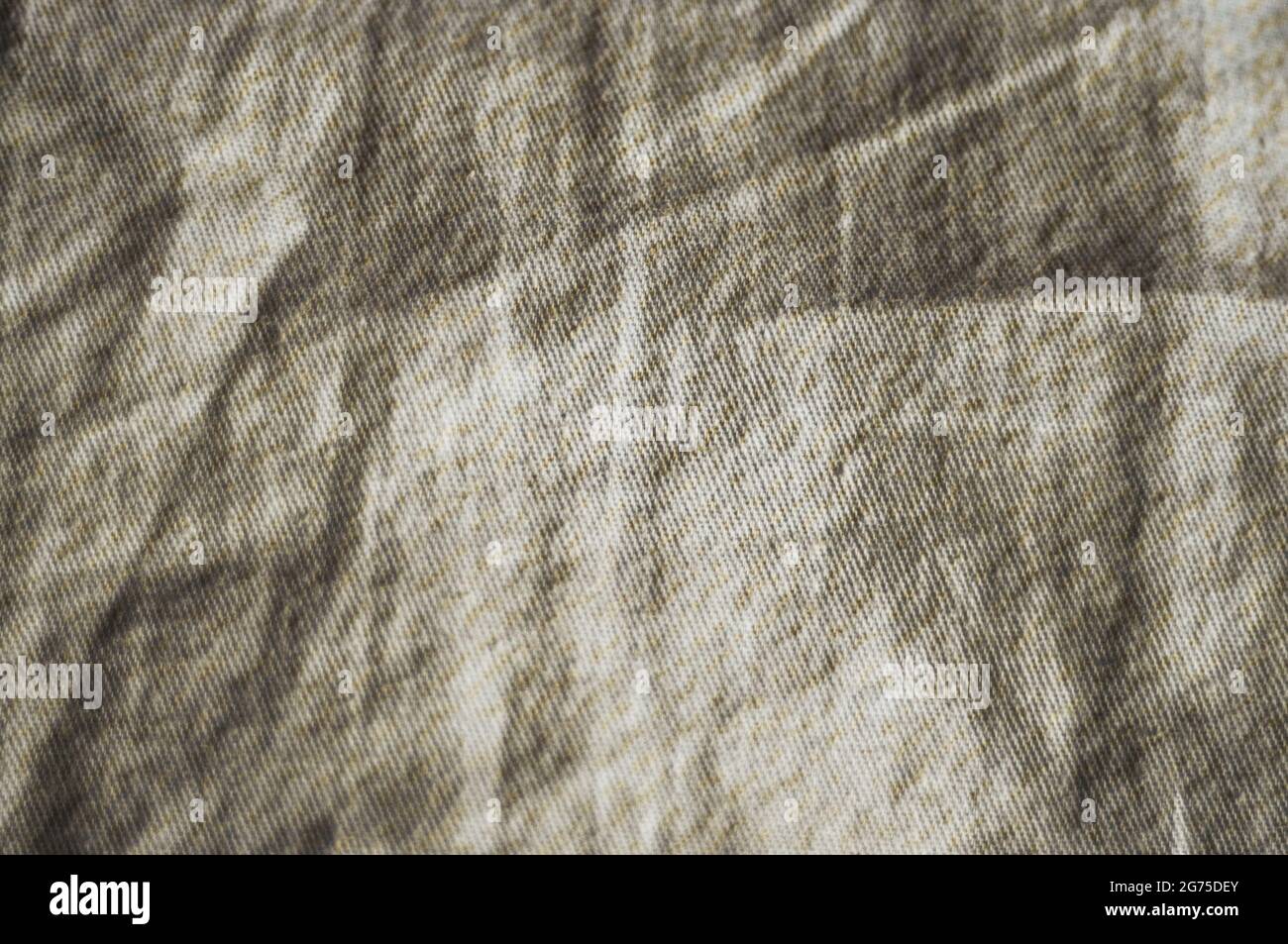 A closeup shot of a mono-color wrinkled canvas fabric under light Stock ...