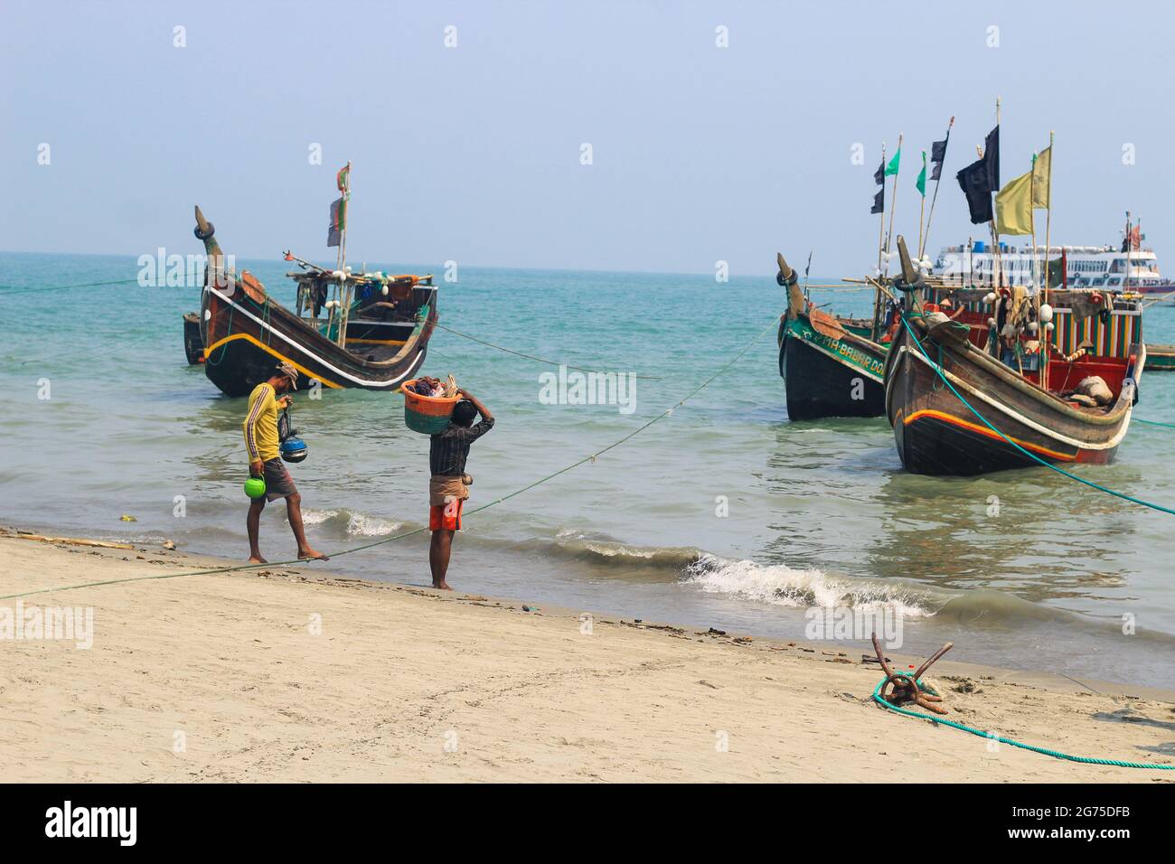 Fishermen and their colorful fishing boats. The fishing industry in ...