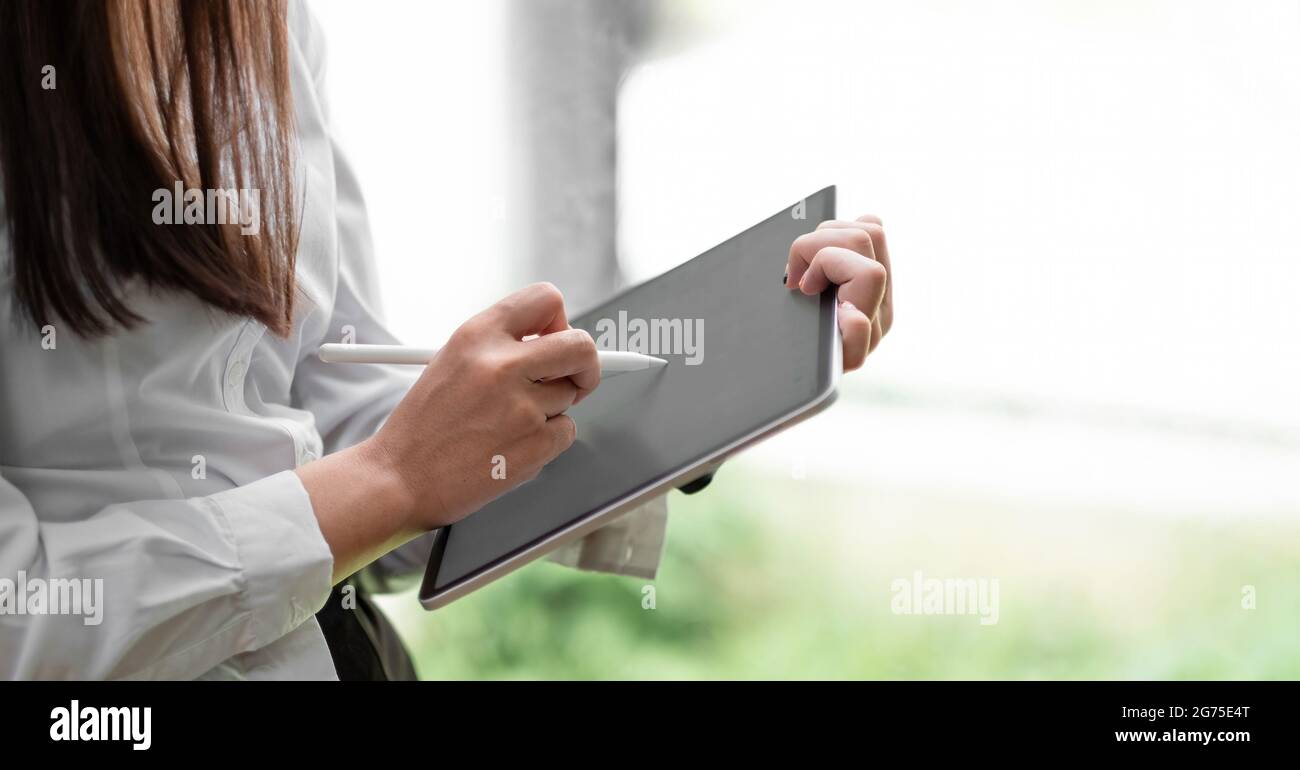 Close up woman hands drawing on digital tablet with electronic pen ...