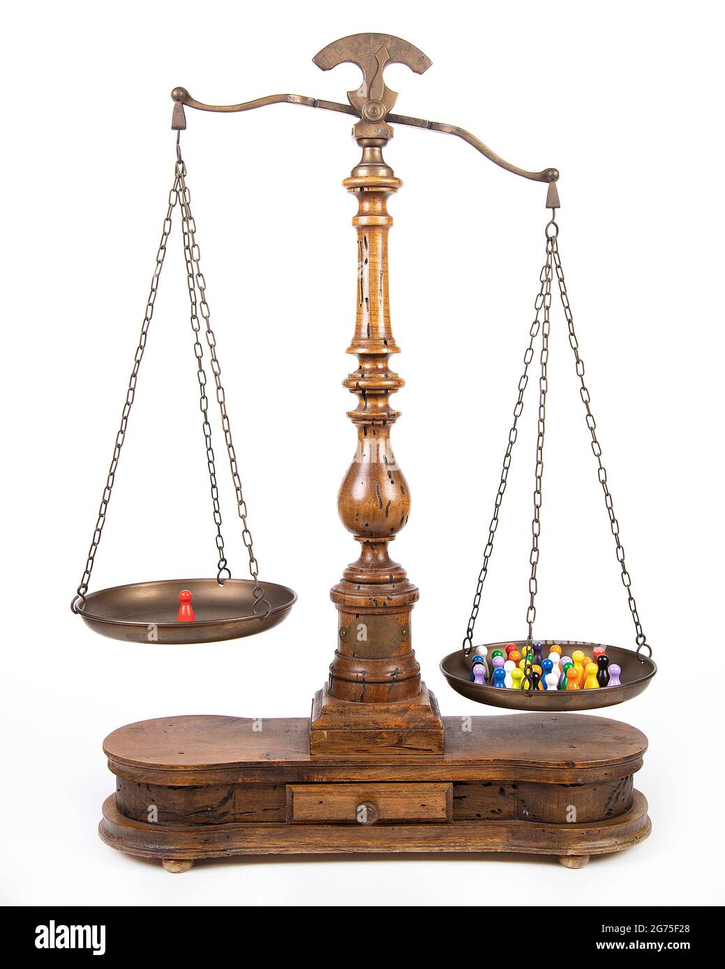 Scale with a wooden figurine on one side and many on the other, as a ...