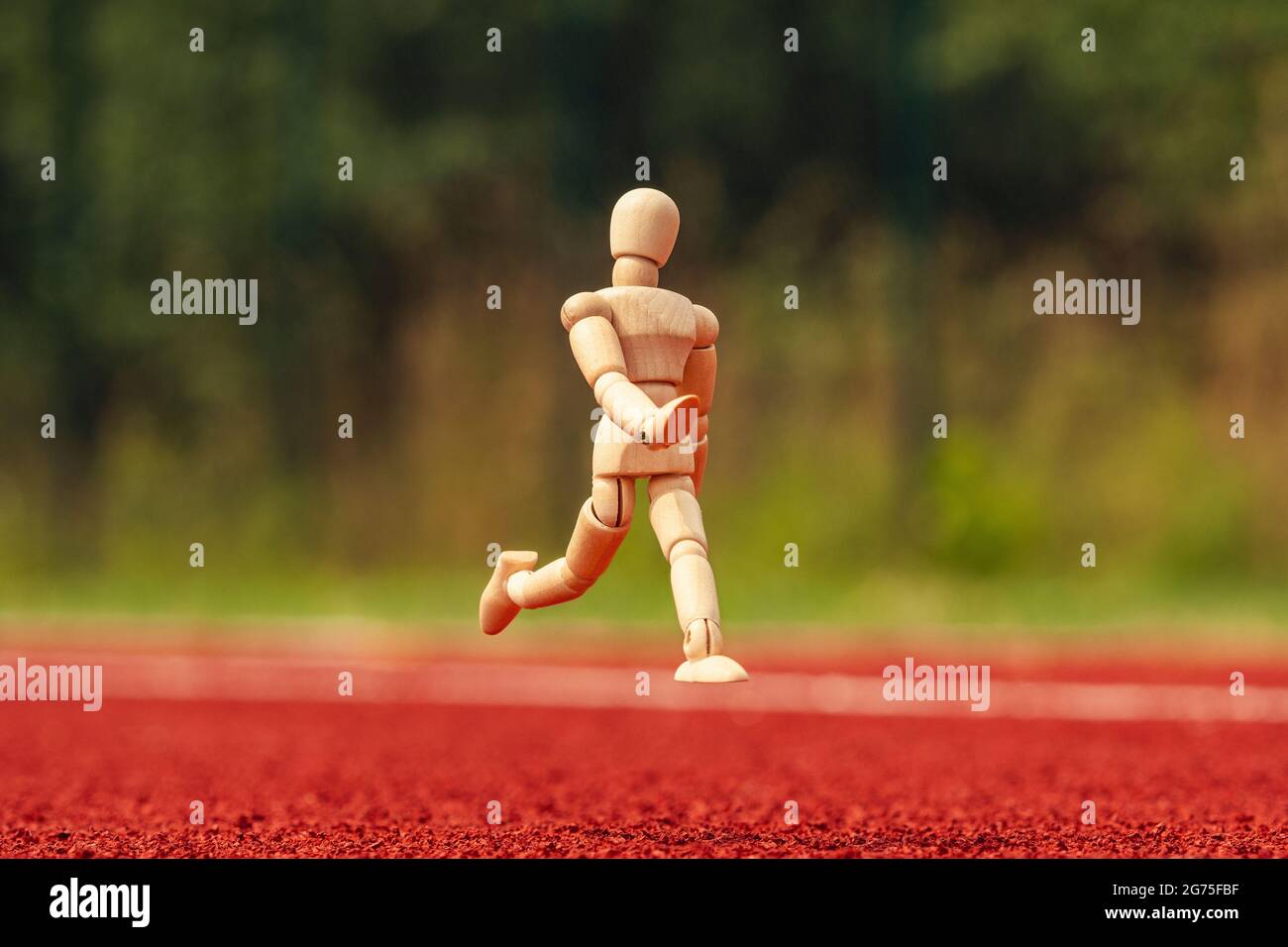 Dummy running on the stadium track with rubber surface Stock Photo - Alamy