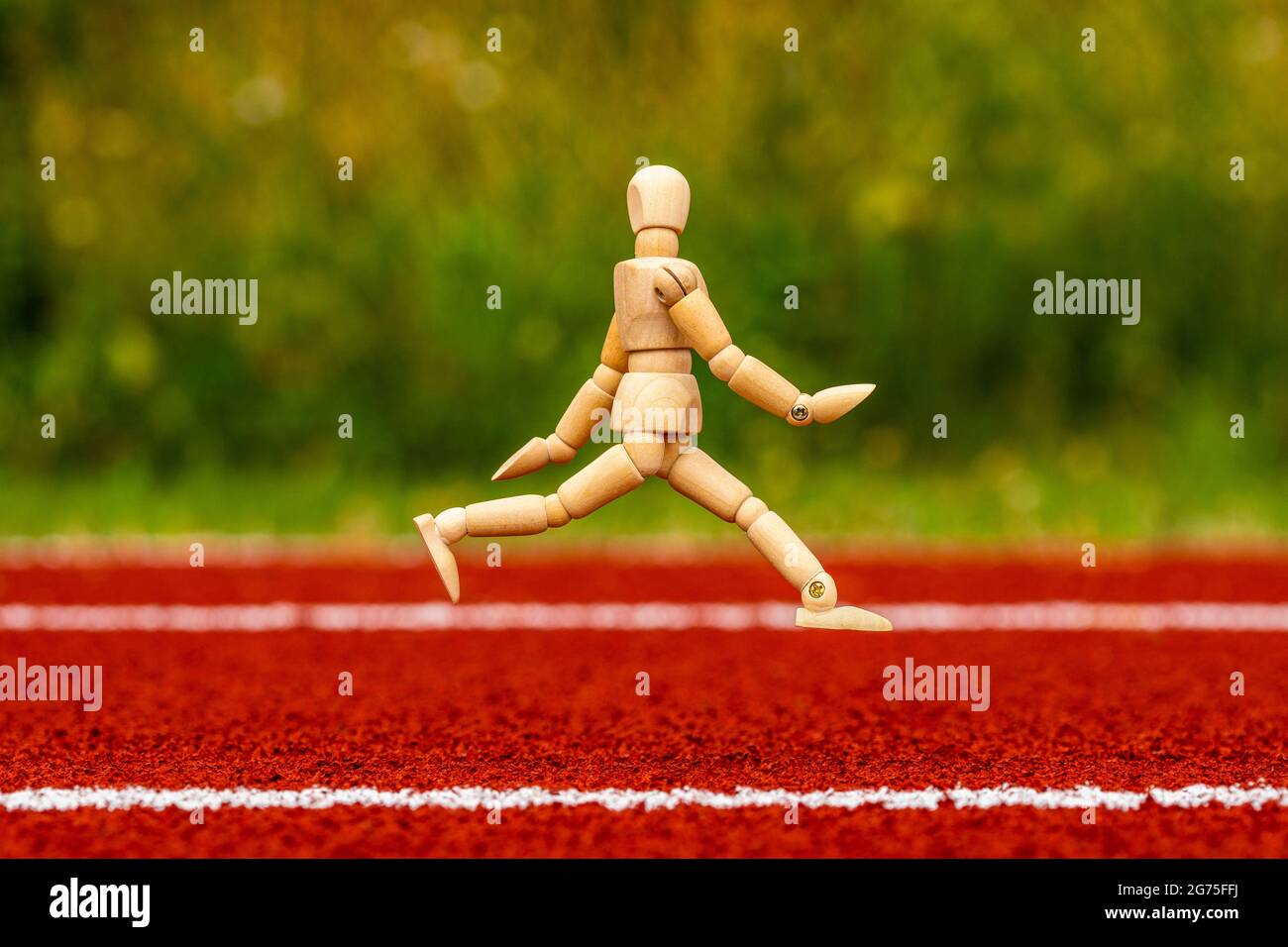 Wooden man running on the stadium track with rubber surface Stock Photo ...