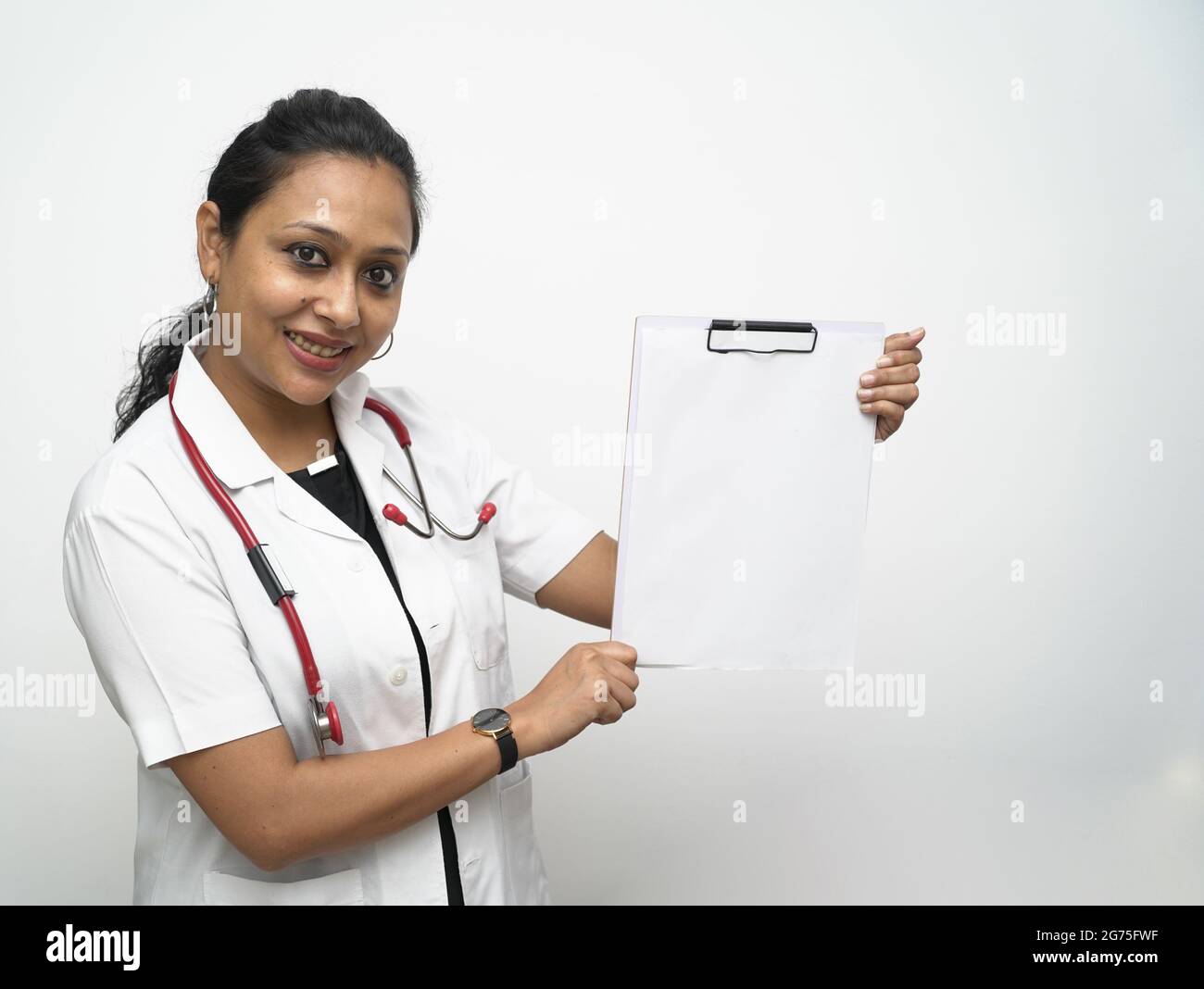 A south Indian female doctor in 30s showing a blank white prescription ...