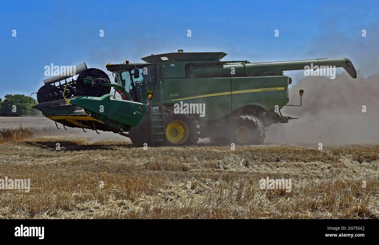 An S770 John Deere combine with a 735FD cutter header attached in the ...