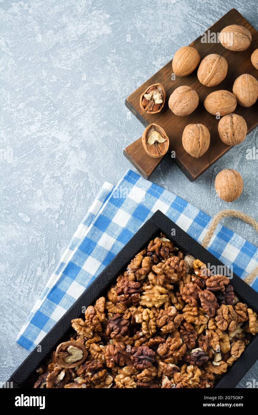 Mature dried walnuts in a wooden box, tasty healthy walnuts. Top view ...