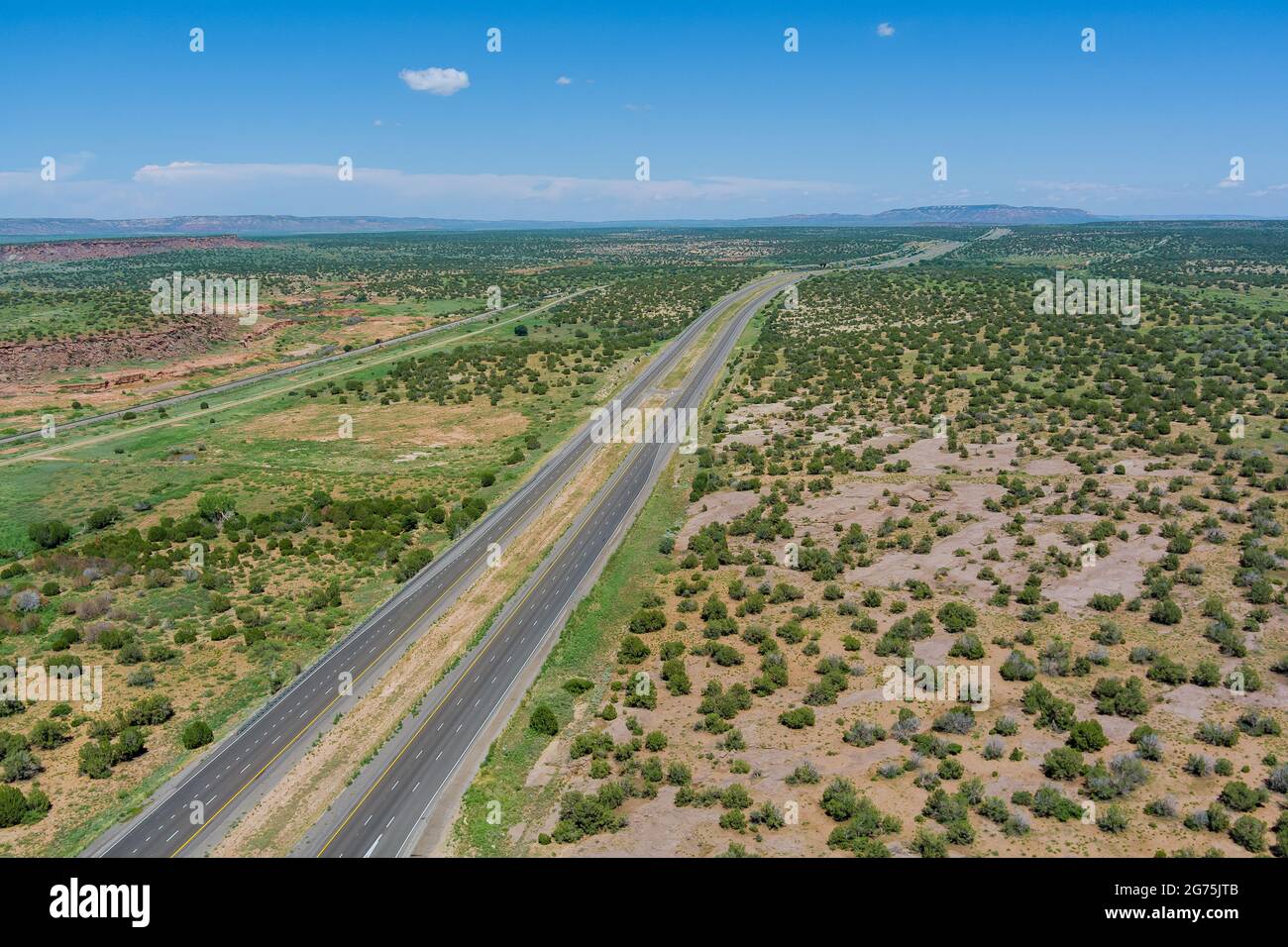 Desert road aerial of a new two lane road surrounded by desert ...