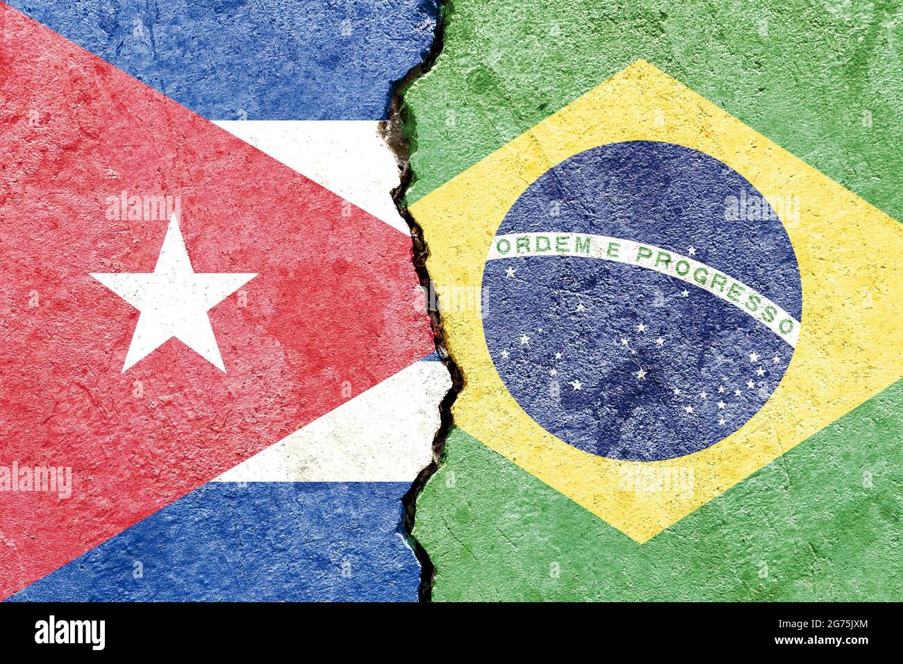 The flags of Cuba and Brazil painted on a weathered broken wall ...