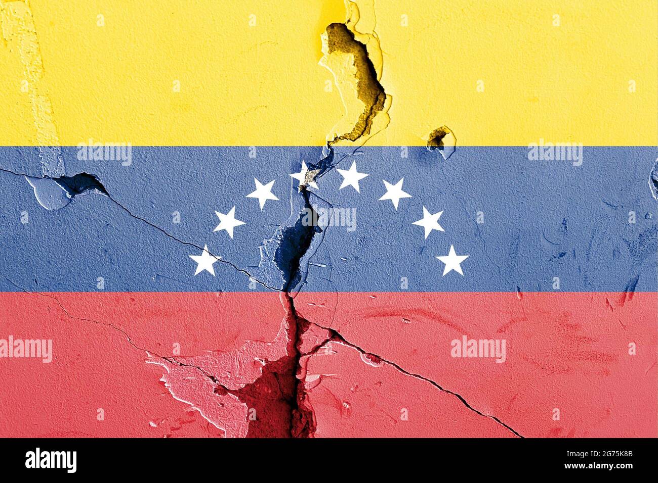 The national flag of Venezuela painted on a weathered broken wall ...