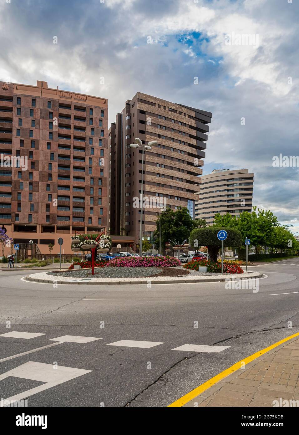 Detail of avenue with buildings in an urban area with a cloudy sky at ...