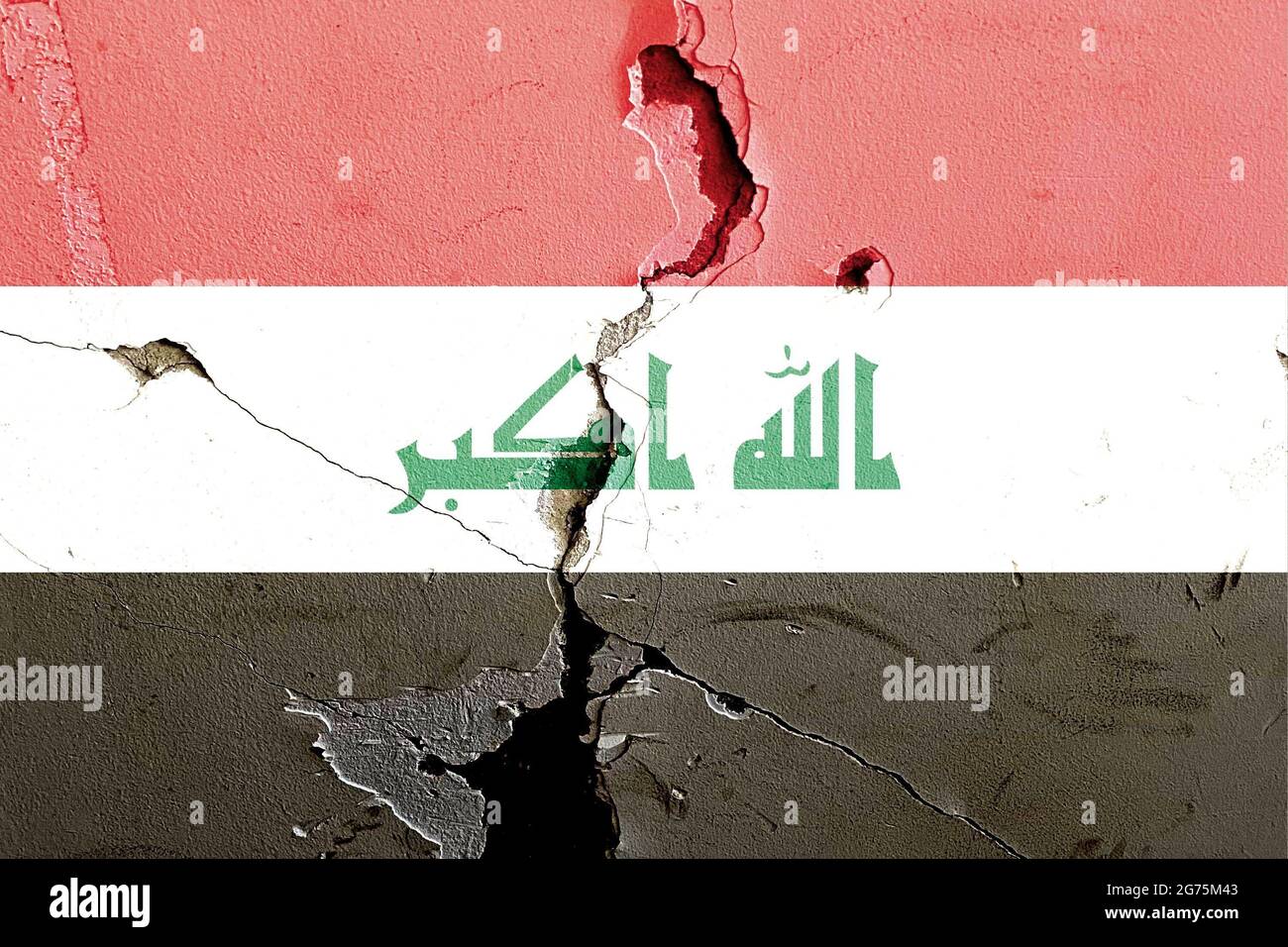 The national flag of Iraq painted on a weathered broken wall ...