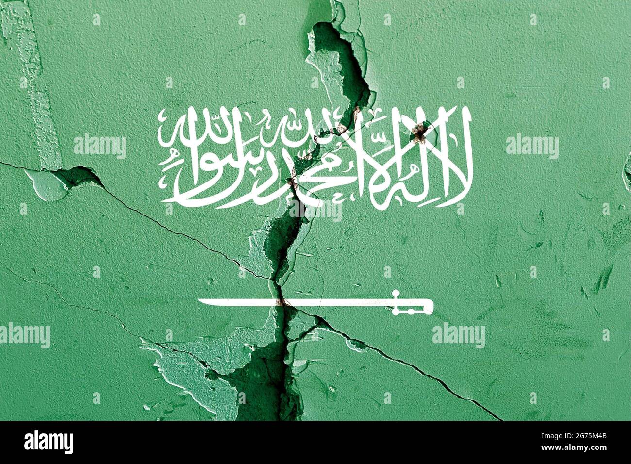 The national flag of Saudi Arabia painted on a weathered broken wall ...