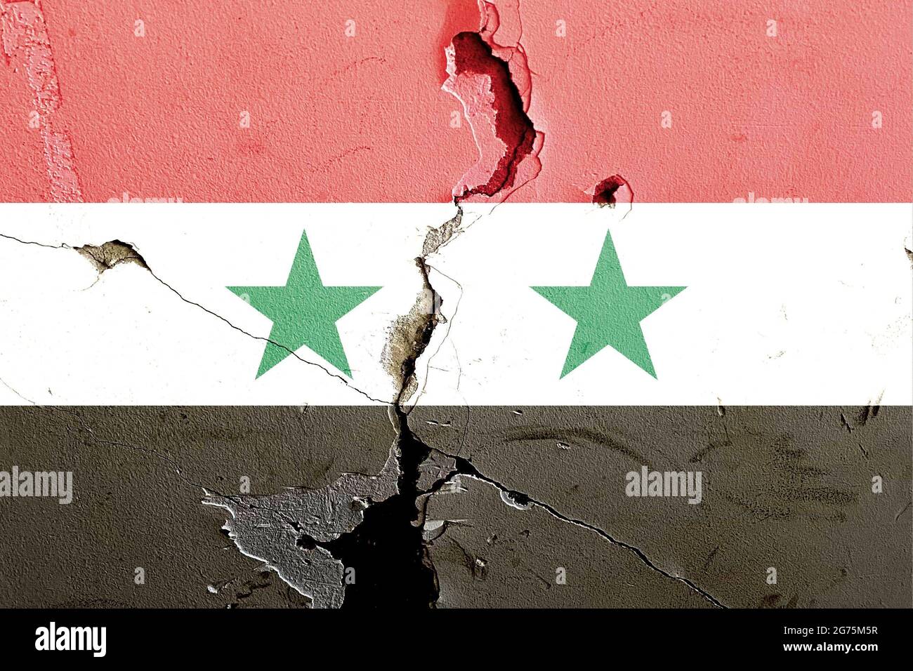 The national flag of Syria painted on a weathered broken wall ...