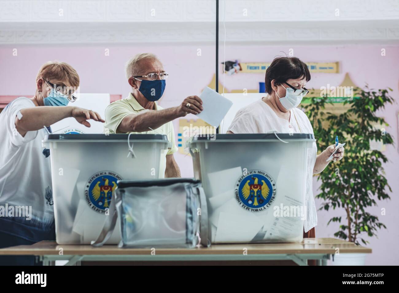 Voters cast their votes at a polling station in Chisinau during the ...