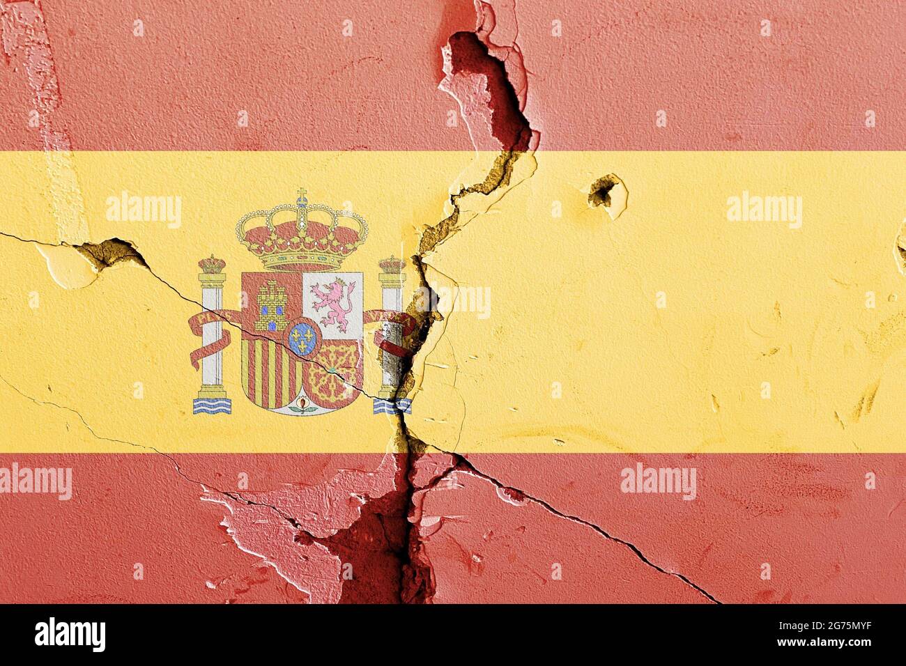 The national flag of Spain painted on a weathered broken wall ...