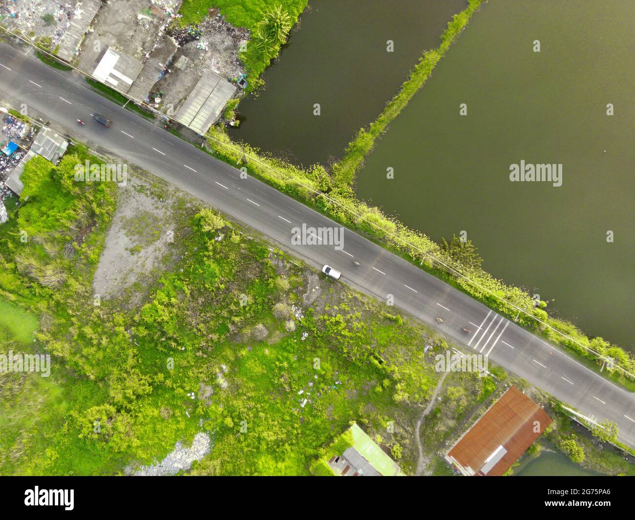 A top view shot of a highway near lakes and agricultural fields Stock ...