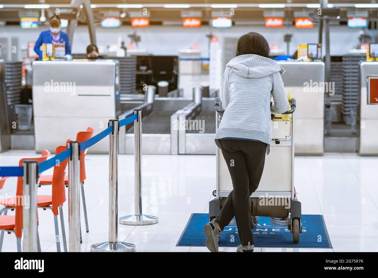 Back view of airline passenger wear face mask to prevent Corona virus ...