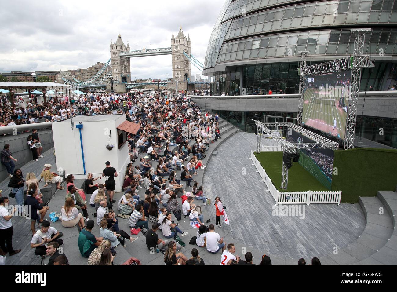 Members of the public watch the Wimbledon men's tennis final on a big ...