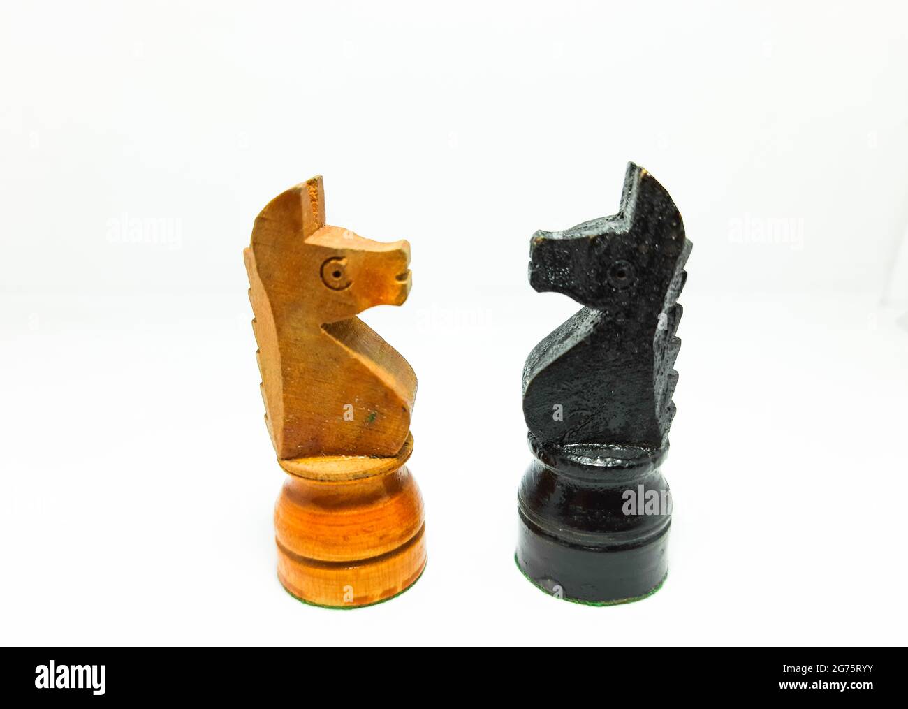 A close up of wooden knights chess pieces black and yellow standing ...