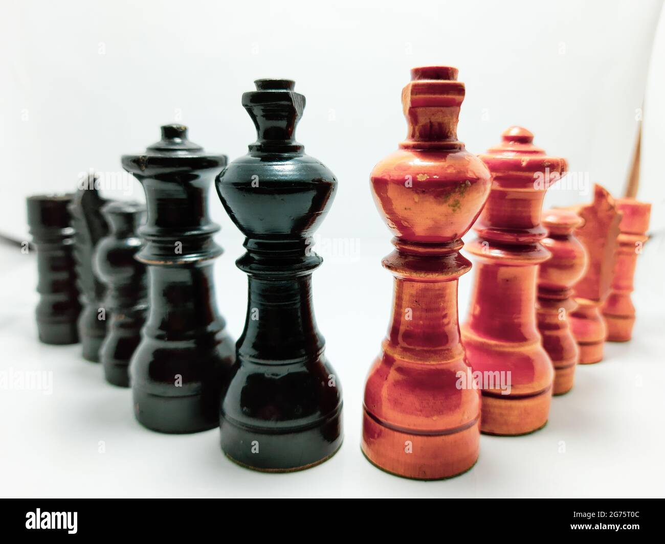A close up of shining chess pieces black and brown standing against on ...