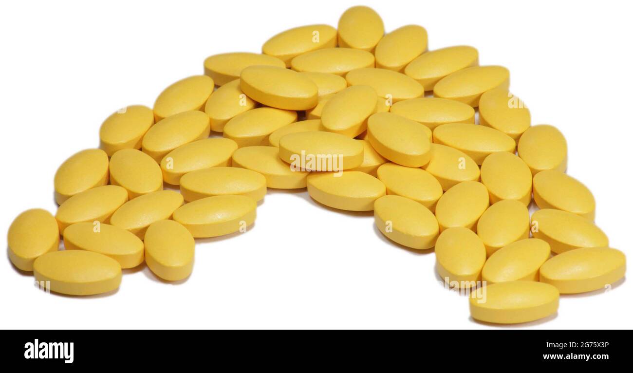 yellow vitamin on white background Stock Photo - Alamy