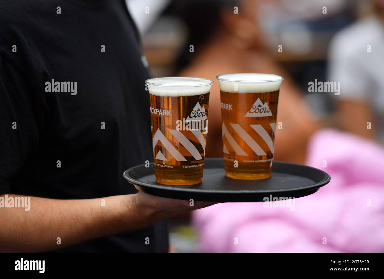 Staff serve a tray of beer at BOXPARK Croydon before the UEFA Euro 2020 ...