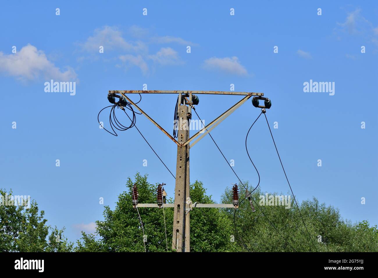 High voltage electric wires among trees. Danger Stock Photo - Alamy