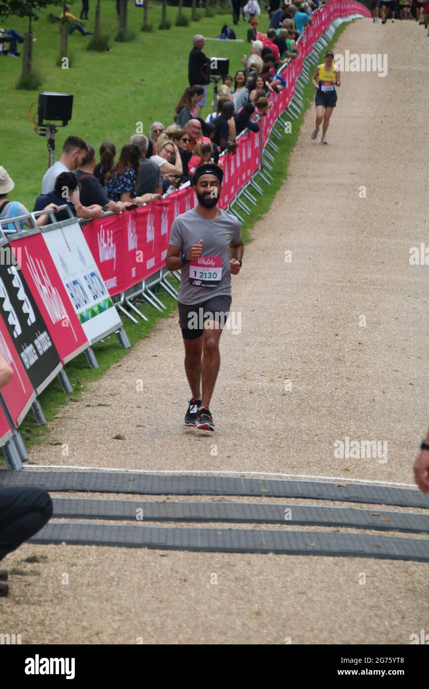 runner coming to the finish line at the end of a race Stock Photo - Alamy