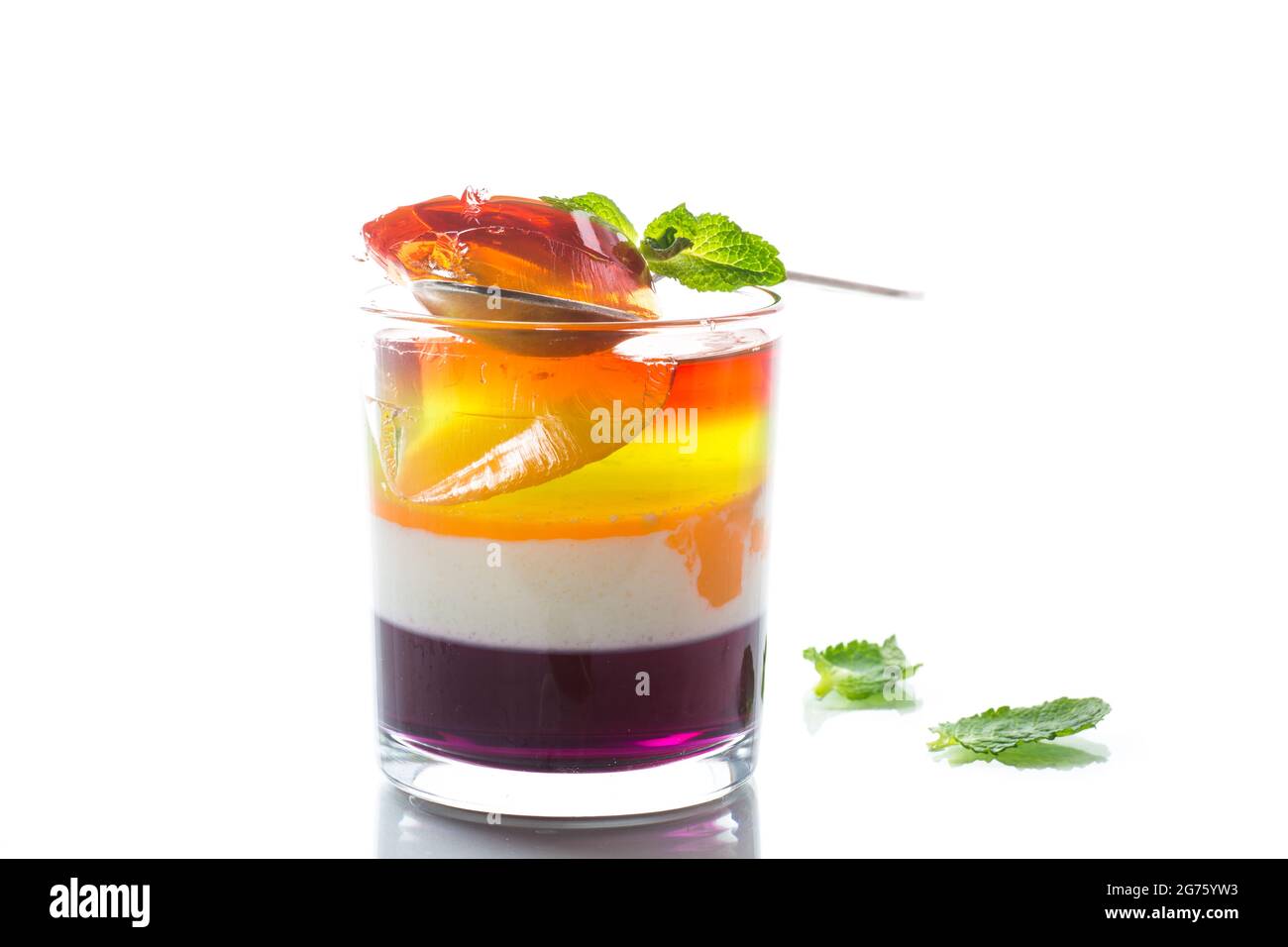 lot of colored sweet fruit jelly in a glass isolated on white ...