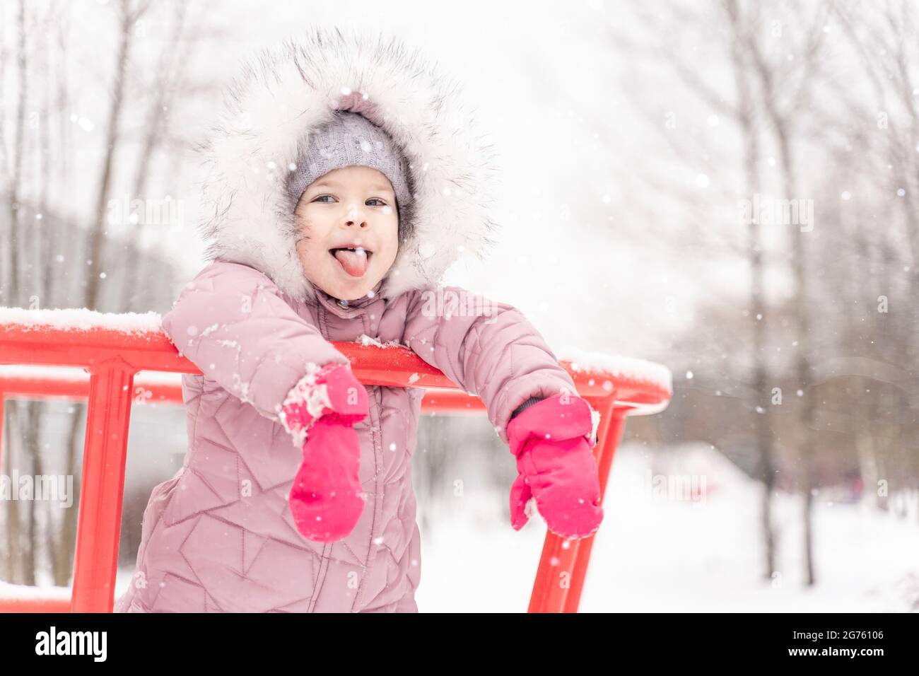 child walks in the park in winter. Outdoors winter activities for kids ...