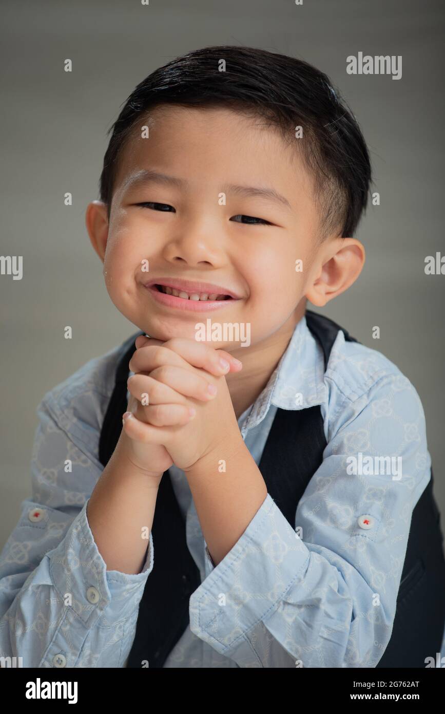 Hands clasped under chin hi-res stock photography and images - Alamy