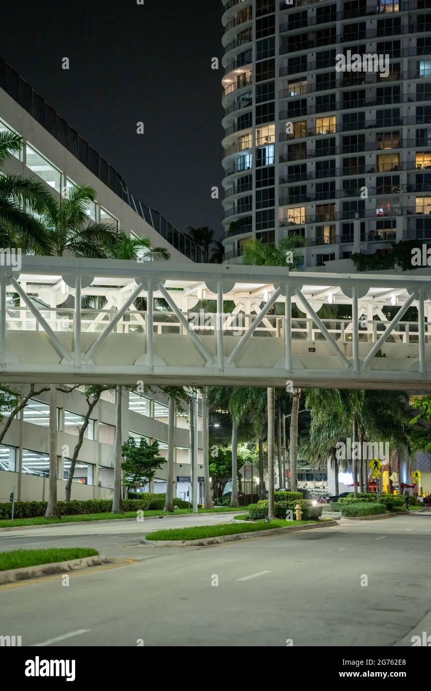 Pedestrian overpass in the city with highrise buildings in background ...