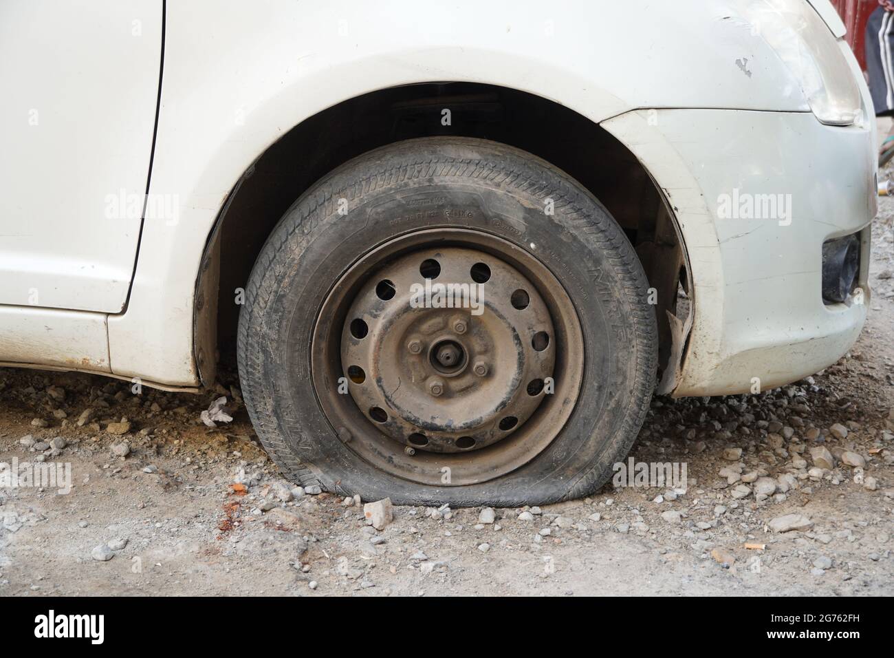 Tire leak, close up wheel of old white vintage car. Car wheel flat tire ...