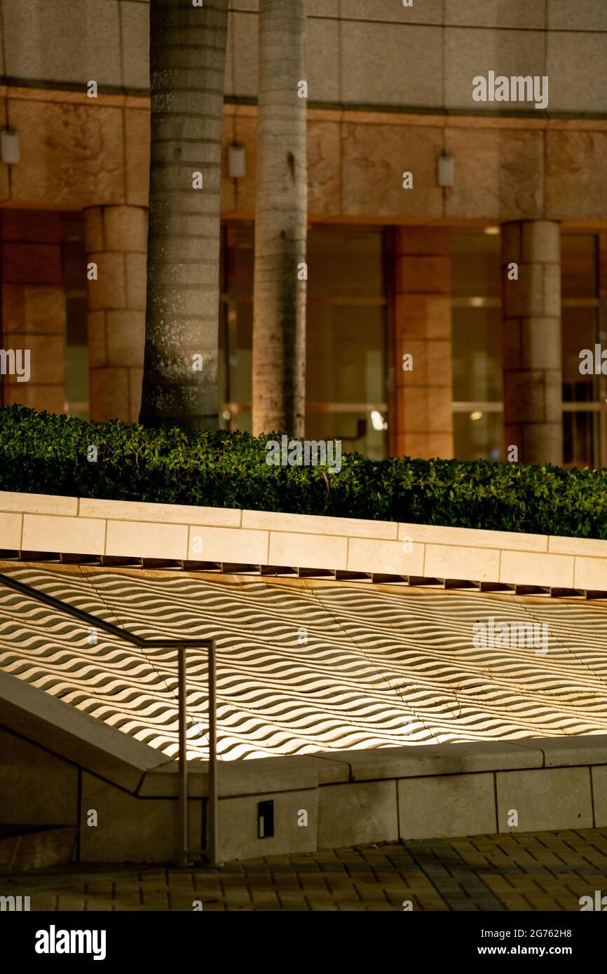 Park scene with wavy shaped lit fountain Stock Photo - Alamy