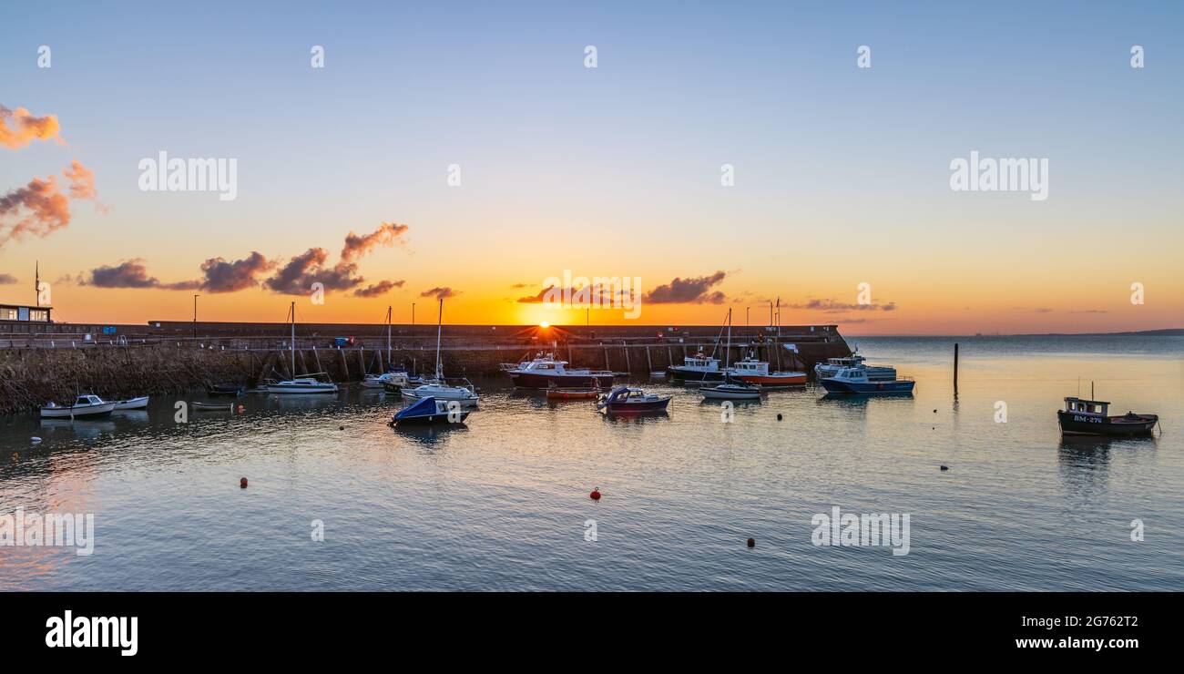 Sunrise over the old harbour at Minehead on the Somerset coast Stock ...