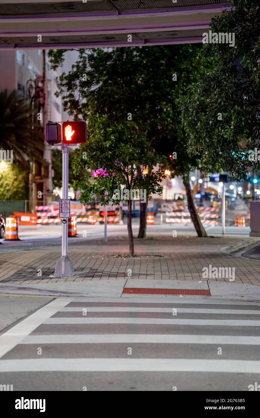 Downtown night city scene painted crosswalk with do not cross sign ...