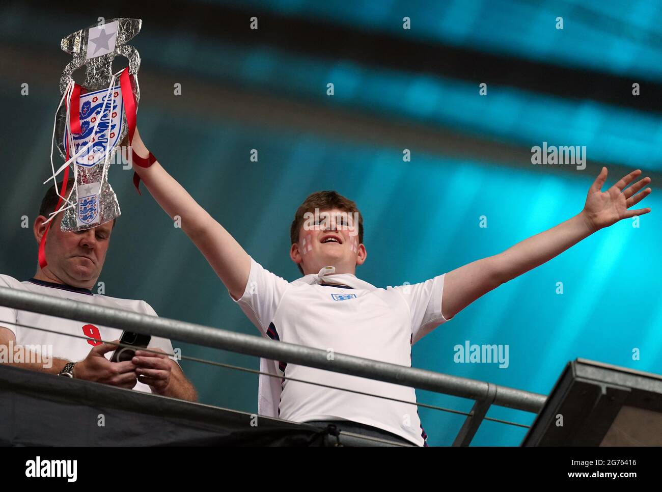 An England fan with a cardboard trophy shows support for his side ahead ...