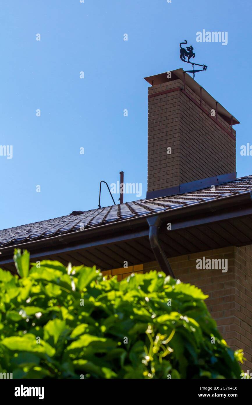 Roof and chimney with vane modern brick rustic cottage. Concept of ...