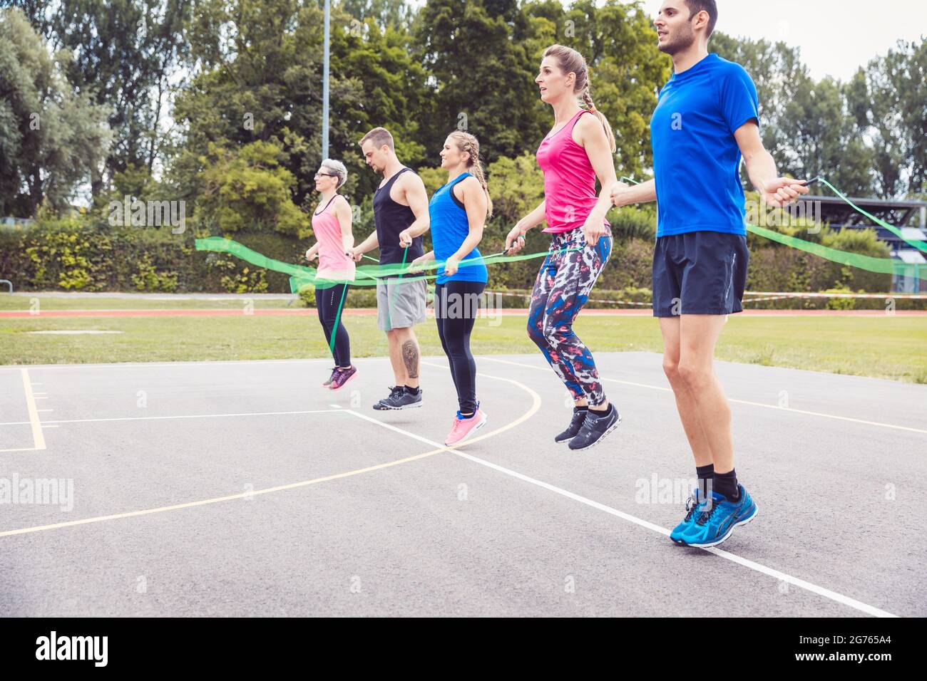Group of people skipping in the park Stock Photo - Alamy