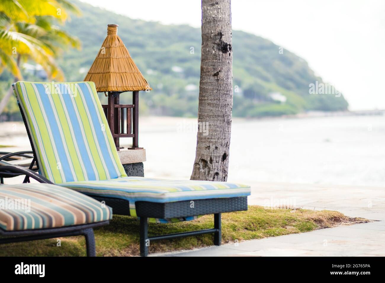 Empty sunbeds on a tropical beach Stock Photo - Alamy
