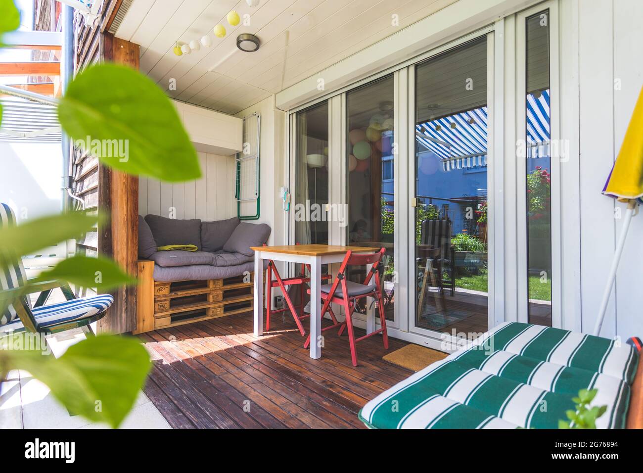 Cozy veranda with little green garden, summer time Stock Photo - Alamy