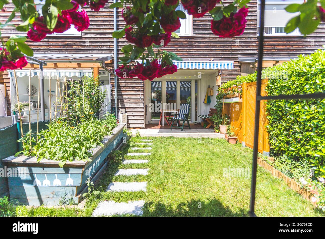 Cozy little green garden with raised bed and veranda, summer time Stock ...