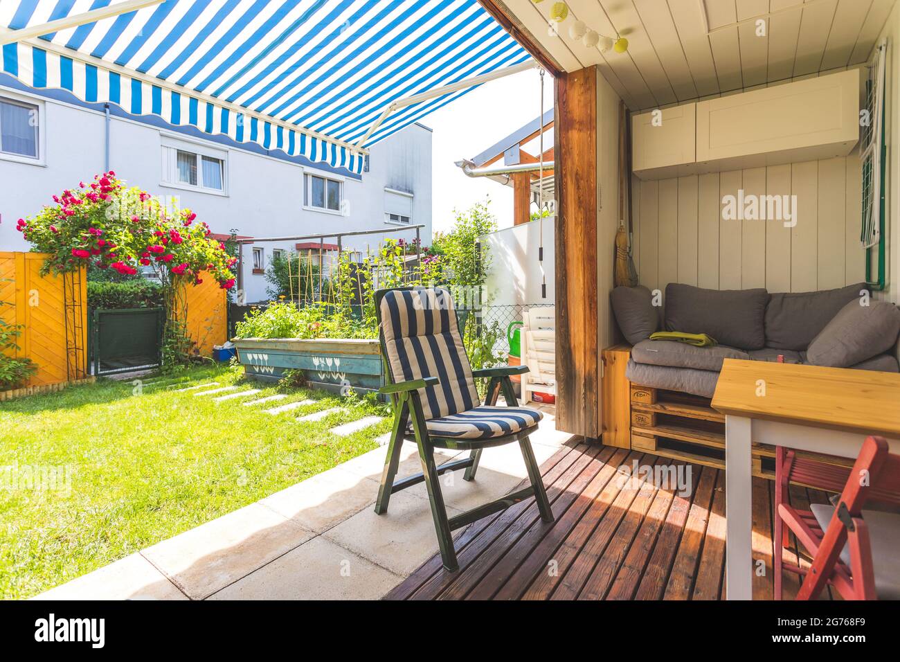 Cozy veranda with little green garden, summer time Stock Photo - Alamy