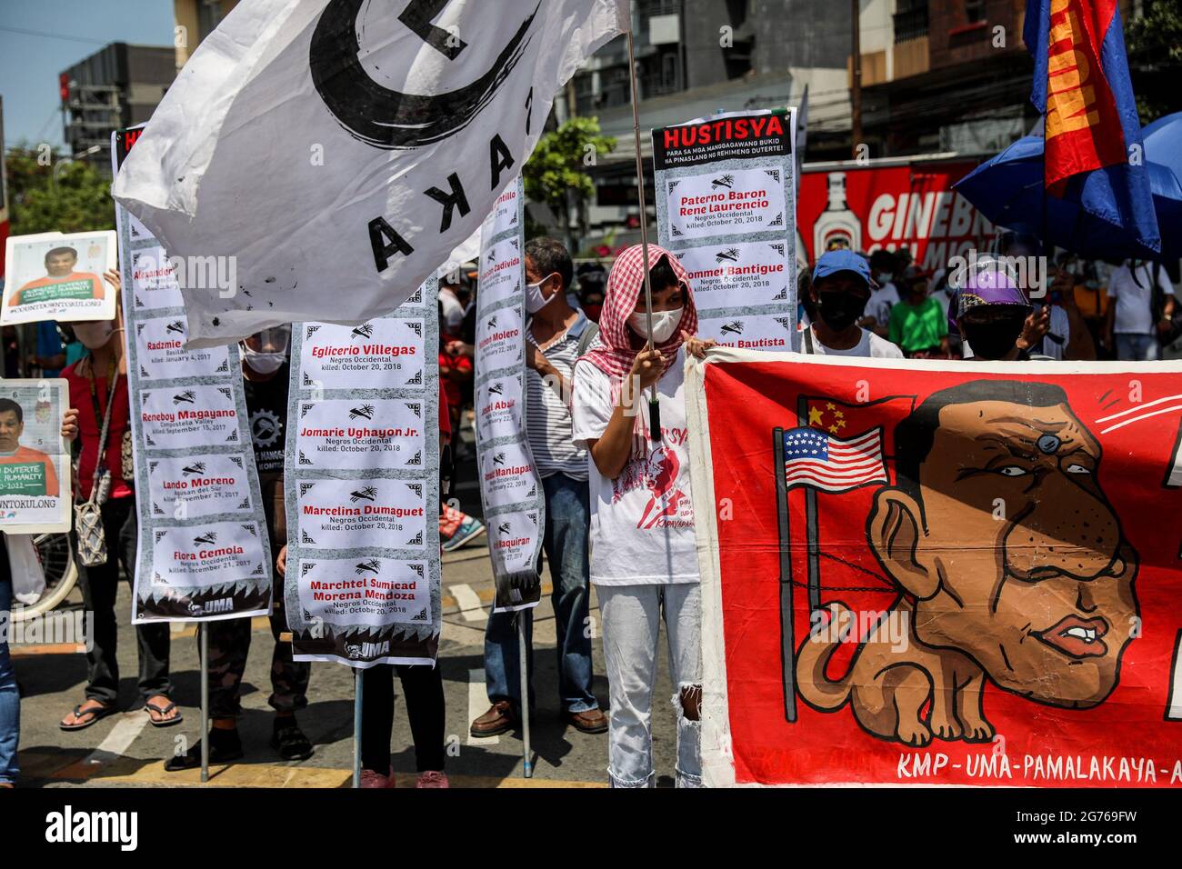 Activists carry signs as various groups protest marking the fifth and ...