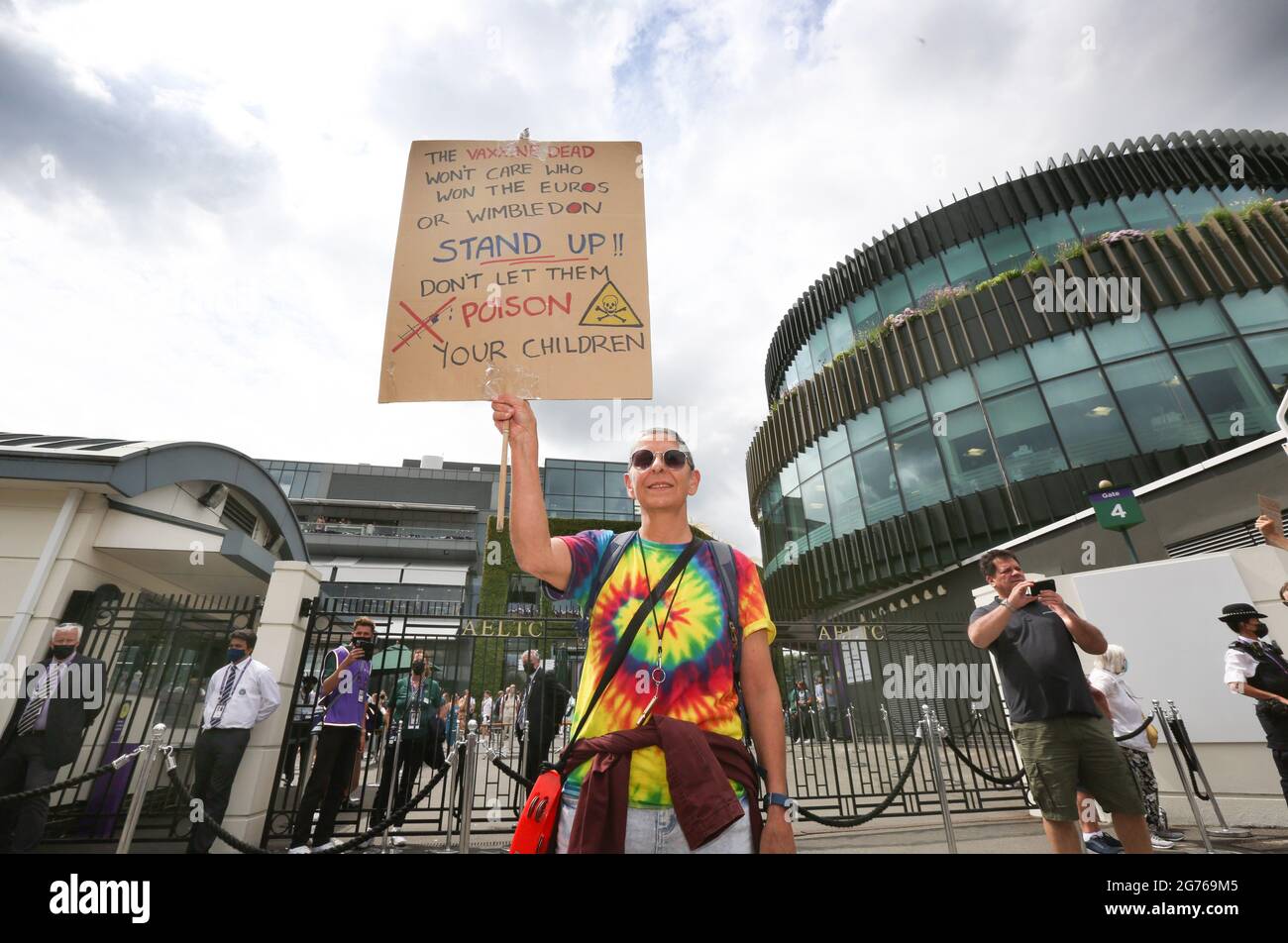 A protester holds a placard expressing his opinion outside Centre Court ...