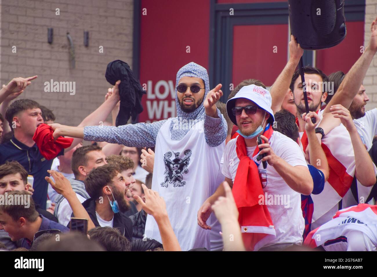 London, UK. 11th July, 2021. An England football fan wears a knight ...